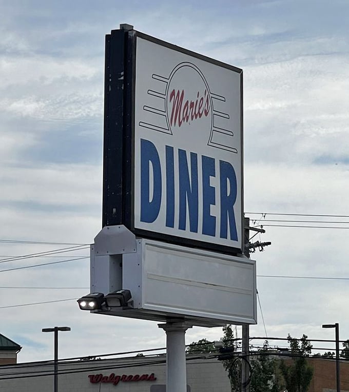 The roadside sign stands tall against the Maryland sky, a landmark for locals and a discovery for travelers seeking authentic diner magic.
