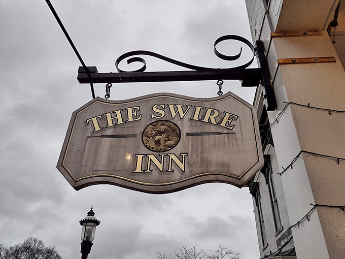 The Swire Inn's vintage sign swinging proudly, a beacon for hungry travelers and locals in the know.