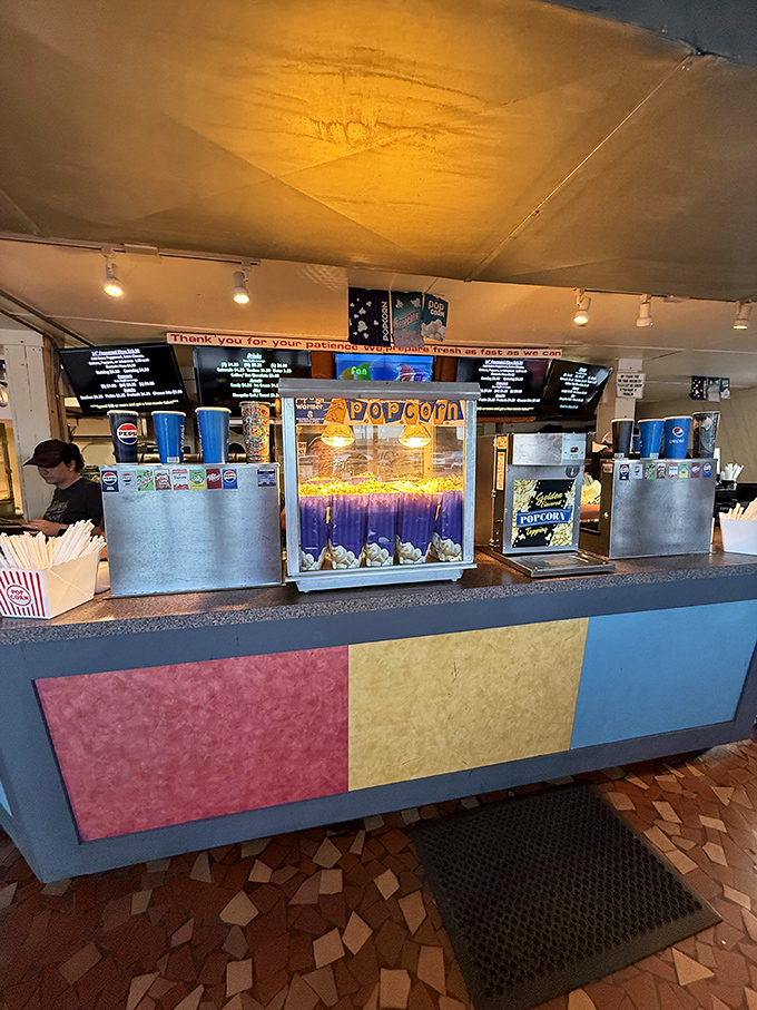 Popcorn machines glow like treasure chests, promising that perfect combination of salt, butter and nostalgia with every kernel.