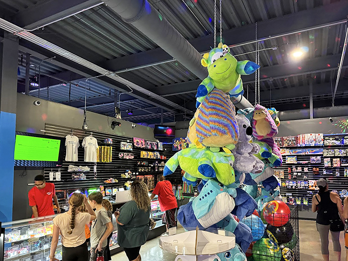 The prize redemption area dangles plush temptations from above, like a colorful reminder that you're never too old to want a stuffed alien.