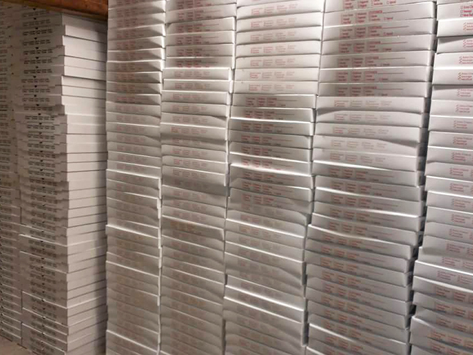 The wall of waiting boxes speaks volumes&mdash;this isn't just a pizza place; it's a community provider preparing for the dinner rush.