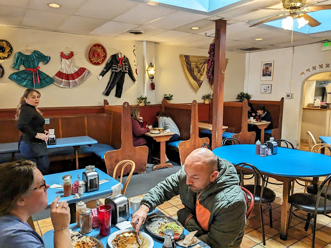 Traditional decorative dresses and sombreros adorn the walls, adding splashes of color to the warm, inviting dining space. Culture you can see and taste.