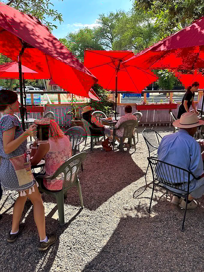 Red umbrellas create a fiesta atmosphere on this casual patio. The gravel underfoot and wooden fence remind you that in Taos, dining is beautifully unpretentious.