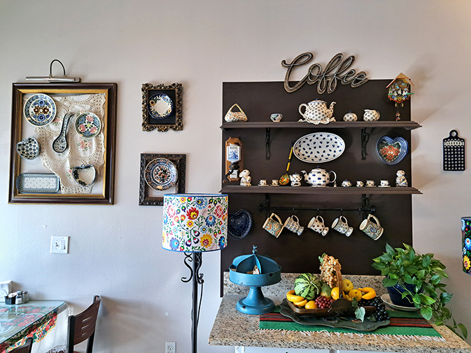 Folk art meets function in this charming corner – colorful pottery, coffee cups, and fresh fruit create a homey tableau.