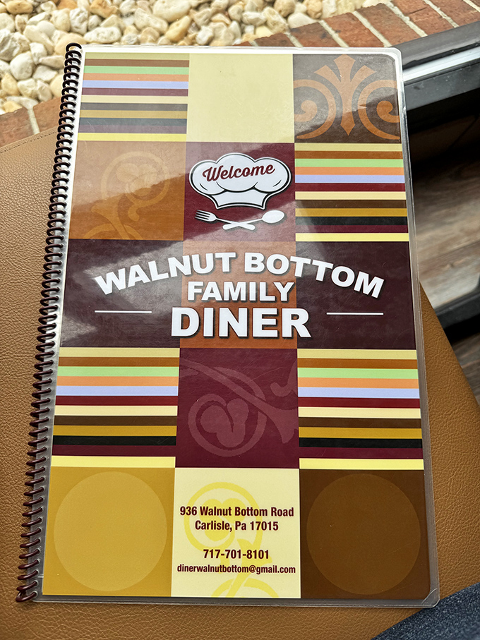 The colorful menu cover that's been handled by countless hungry hands, promising familiar comforts and new discoveries with each visit.