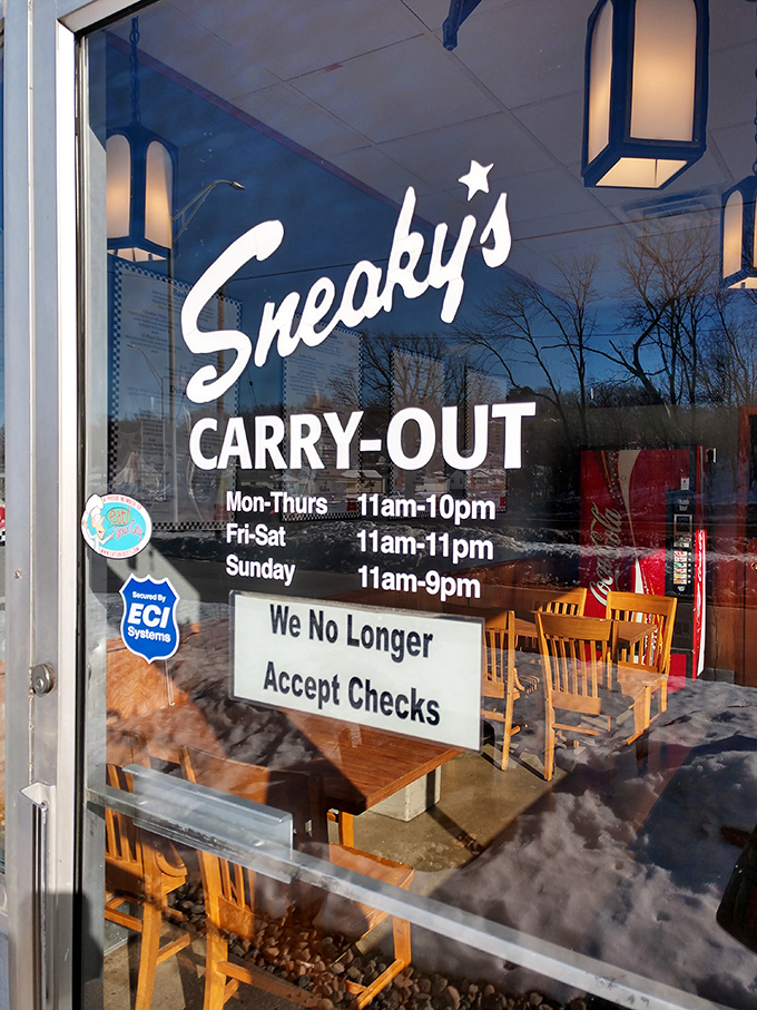 The door announces Sneaky's generous hours, ensuring you're never too far from your next fried chicken fix in Sioux City.
