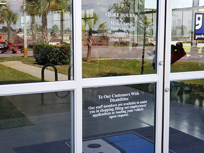 Store hours posted clearly for bargain hunters planning their expeditions. The palm trees outside remind you this is definitely Florida.