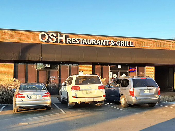 As the sun sets, OSH's storefront glows with promise. Cars in the parking lot tell the story&mdash;locals know where the good stuff is.