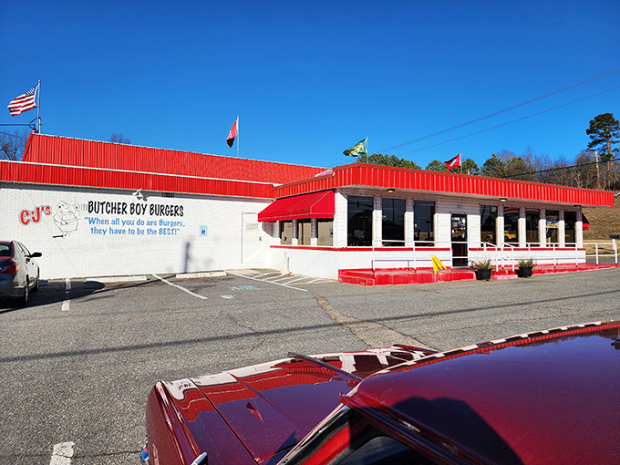 CJ's stands sentinel along the roadside, its red roof a beacon calling to hungry travelers like a meaty lighthouse.