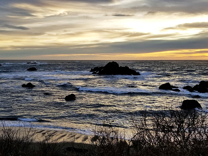 Sunset transforms the rugged coastline into a painting worthy of a gallery. The rocky outcroppings create nature's own sculpture garden against the golden light.