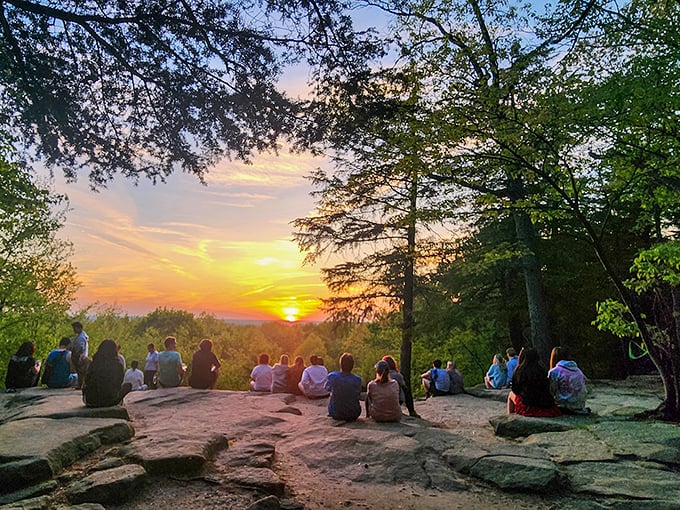 Sunset congregation&mdash;where strangers become momentary friends united by collective gasps as day bids farewell.