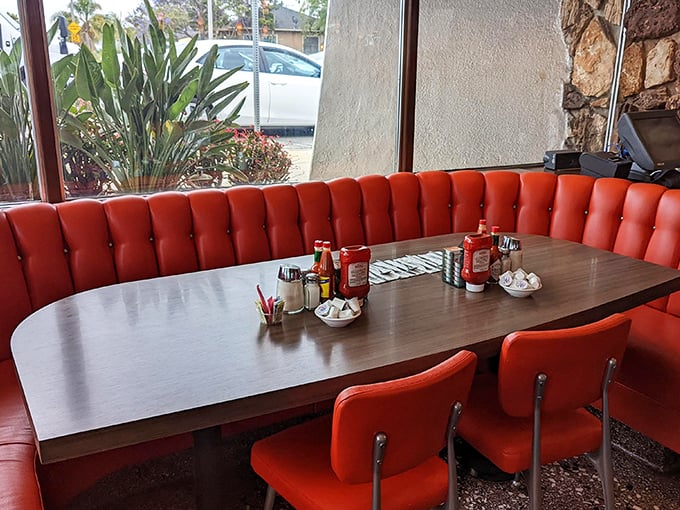 These red booths don't just seat you&mdash;they embrace you in vinyl comfort while condiments stand at attention, ready for duty.
