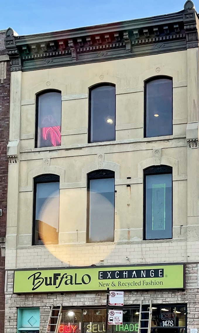 By day, the historic building houses fashion treasures; by night, its illuminated windows create a glowing gallery of sustainable style on Milwaukee Avenue.