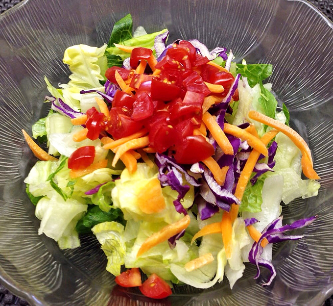 Even the salad looks happy to be here, bright and crisp like it knows it's the opening act for the fried chicken headliner.
