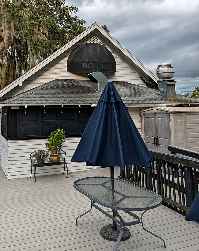 The restaurant's outdoor deck offers dining under the watchful gaze of Spanish moss, where Florida breezes enhance every bite.