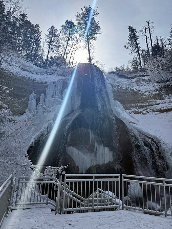 The viewing deck in winter offers front-row seats to nature's most exclusive show: a partially frozen waterfall that refuses to quit.