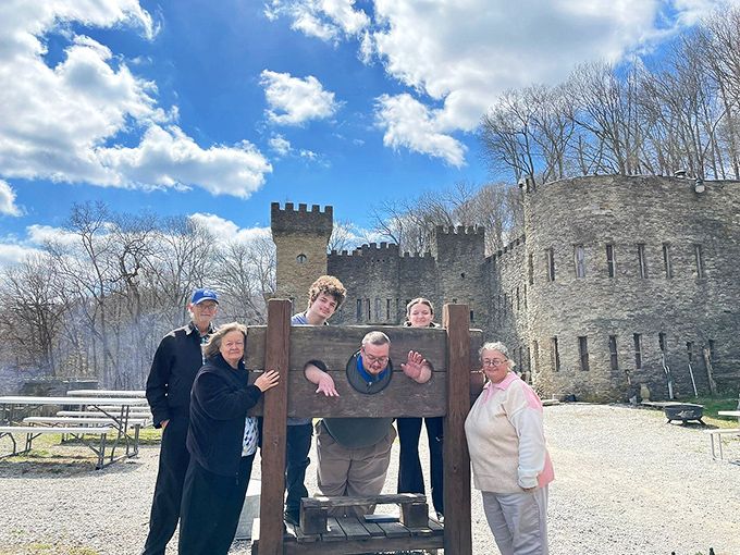 Modern-day visitors enjoy a classic castle punishment device. Nothing says "family fun" quite like pretending to be locked in medieval stocks!