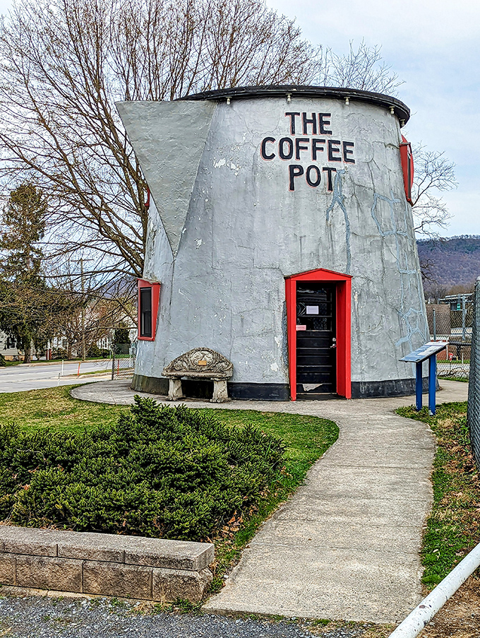 The welcoming pathway invites curious travelers to approach this architectural oddity, promising a brief but memorable detour into the delightfully unexpected.