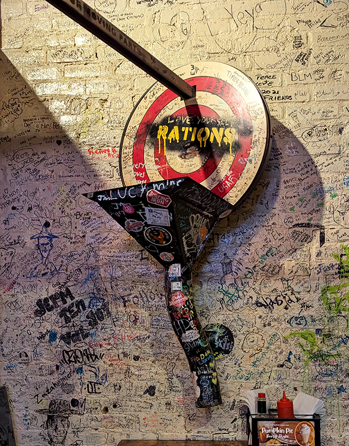The graffiti wall serves as a living guestbook, where the bullseye target reminds you that good food is always worth taking aim at.
