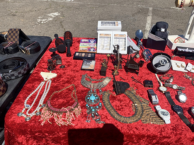 Jewelry and accessories spread across vibrant red fabric create displays that rival any high-end store's presentation style.