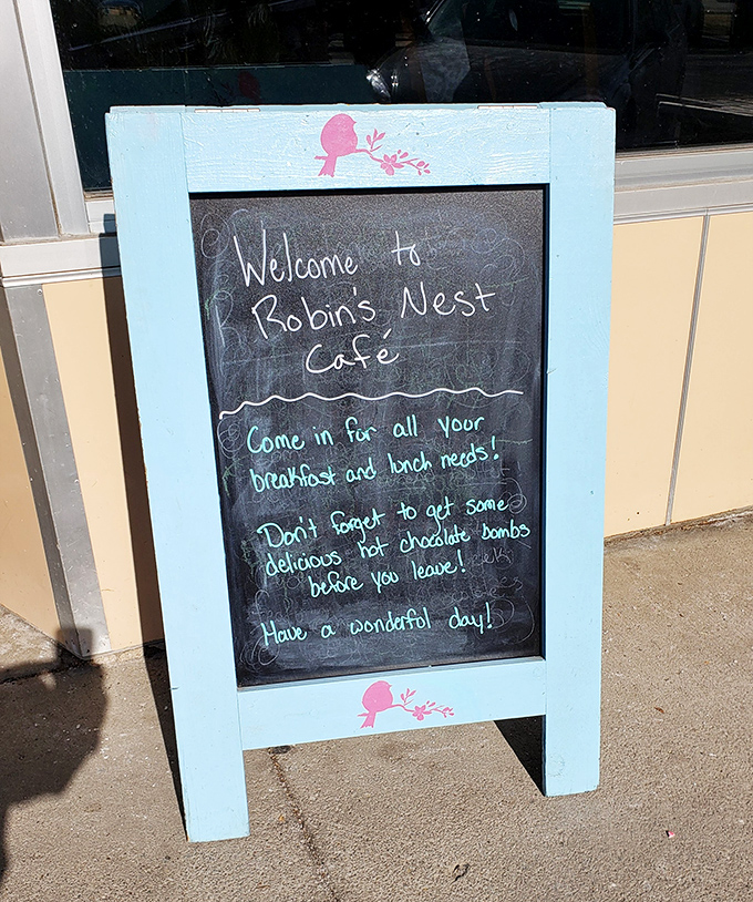 Handwritten chalk messages promise chocolate bombs and breakfast needs with genuine small-town hospitality warmth.