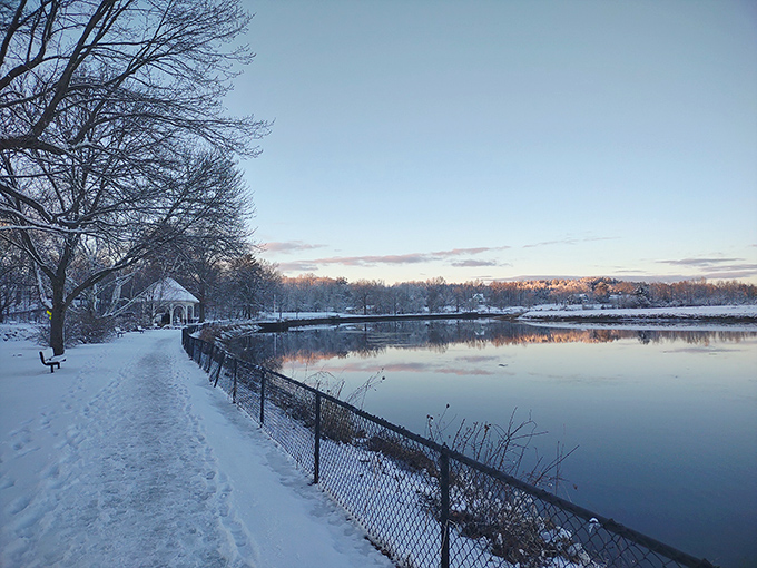 Winter's hush blankets Swasey Parkway in snow while the river refuses to freeze, a perfect metaphor for Exeter's blend of tranquility and persistent energy.