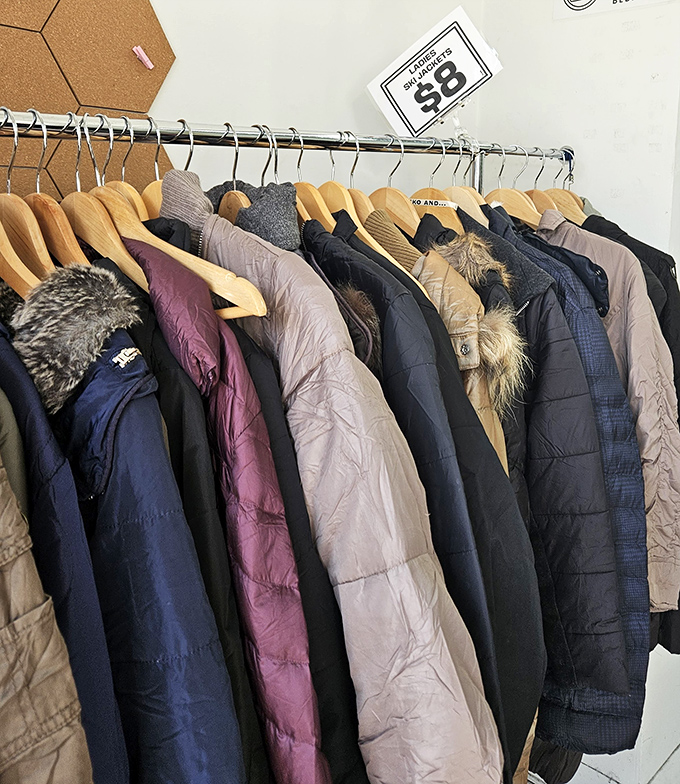 Winter coats lined up like old friends waiting to be rediscovered. That purple puffer? It's about to become someone's signature piece.