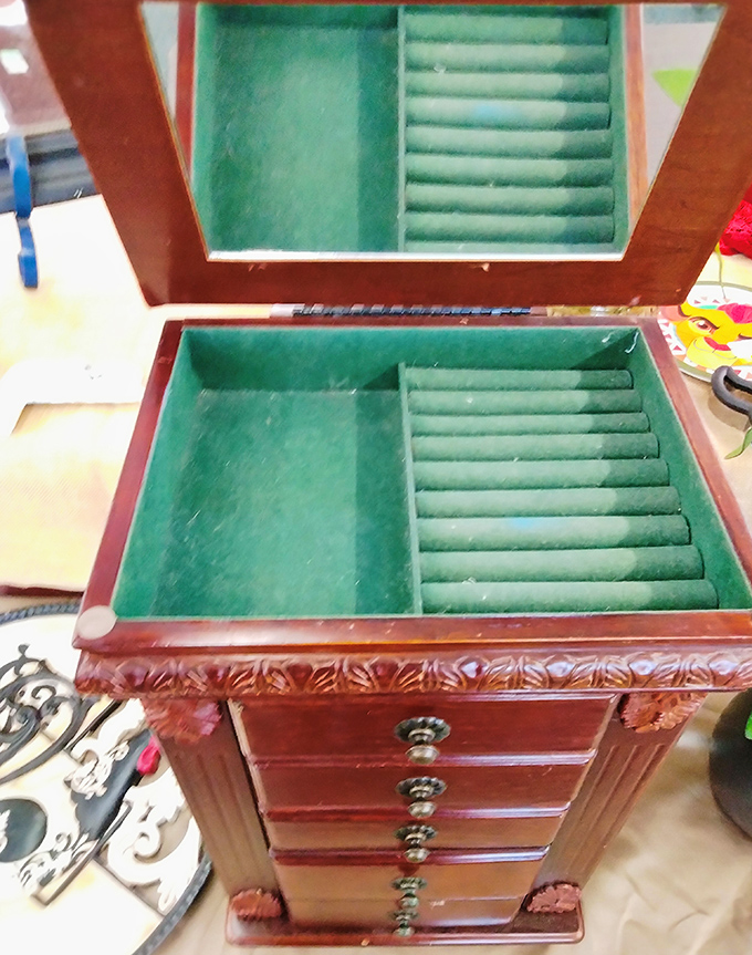 That jewelry armoire with its mint-green interior is practically begging to organize someone's treasured collection beautifully.