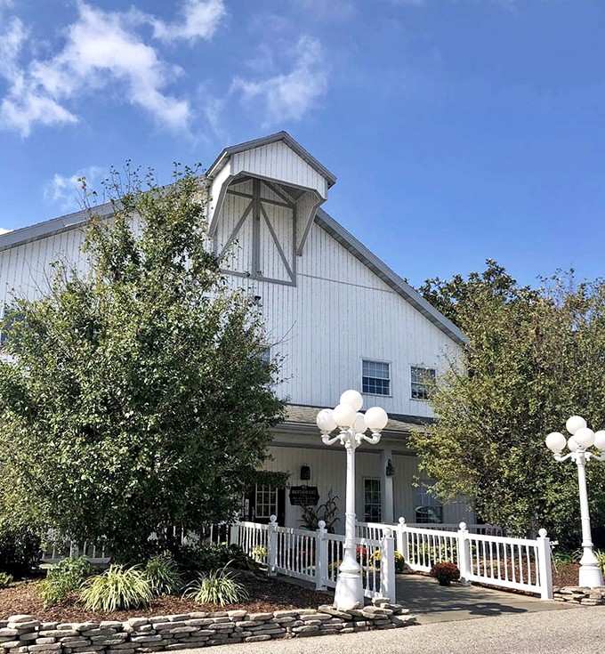 The welcoming entrance with its manicured landscaping and globe lights hints at the homestyle magic waiting inside those barn doors.