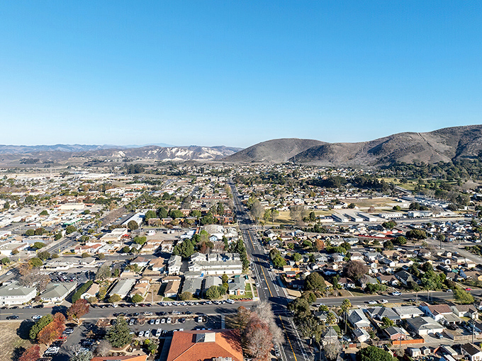 Lompoc unfolds beneath blue skies, nestled between protective hills. From above, you can see why retirees call this affordable paradise home.