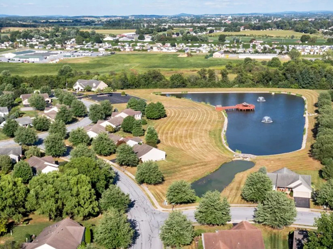 The bird's-eye view reveals the master plan &ndash; homes nestled around water, not squeezed between parking lots. Retirement reimagined from above.
