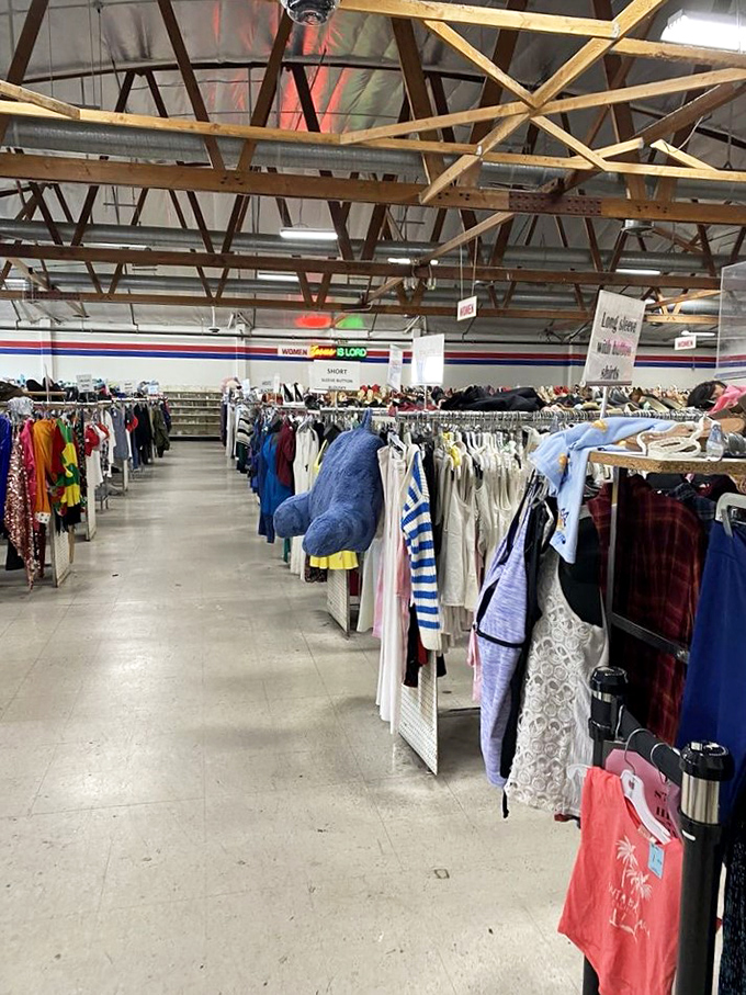 The view down the aisle feels like gazing into retail infinity. Each rack a new chapter in the never-ending story of secondhand shopping bliss.