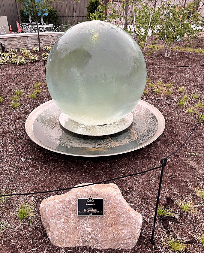 The mysterious Aquasphere stands like a crystal ball, holding all the garden's secrets in its glassy depths.