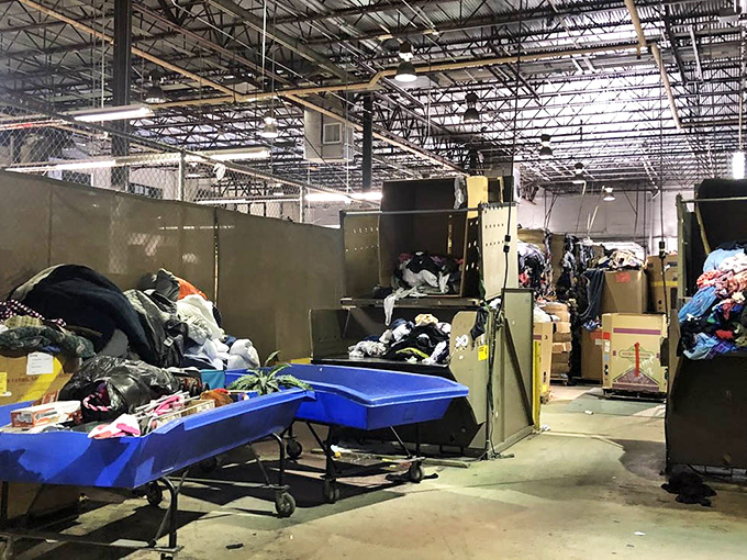 Behind the scenes of bargain magic. The sorting area reveals the methodical chaos that transforms donations into organized shopping opportunities.