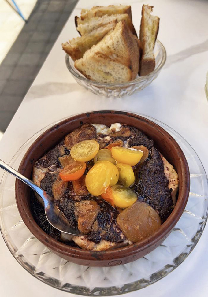 This isn't just baked feta&mdash;it's a Mediterranean vacation in a terracotta dish. Those blistered tomatoes burst with concentrated sunshine.