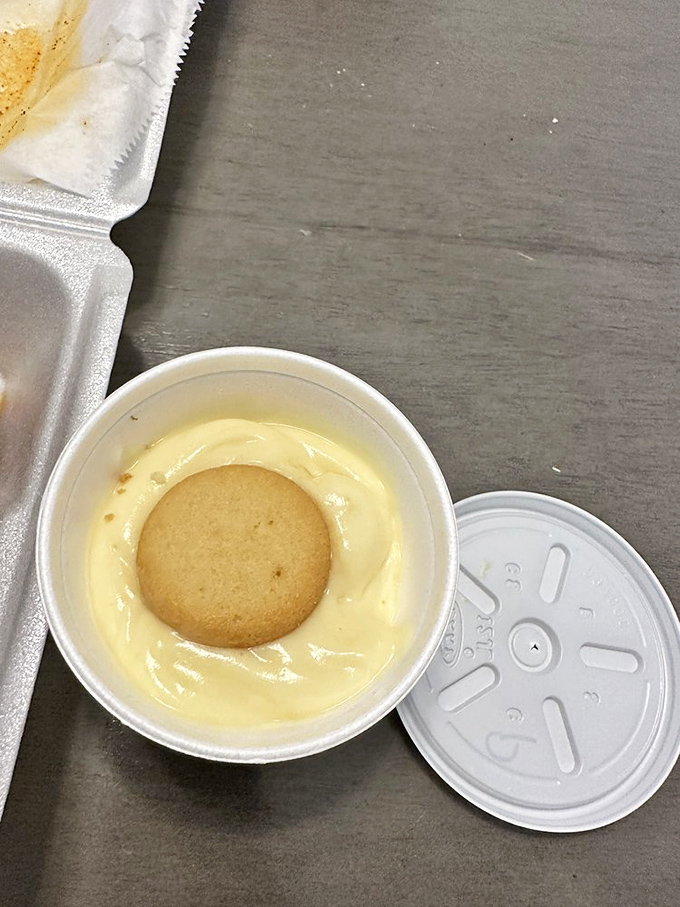 The perfect finale to a fiery feast: creamy banana pudding with a vanilla wafer island, offering sweet relief to heat-stricken taste buds.