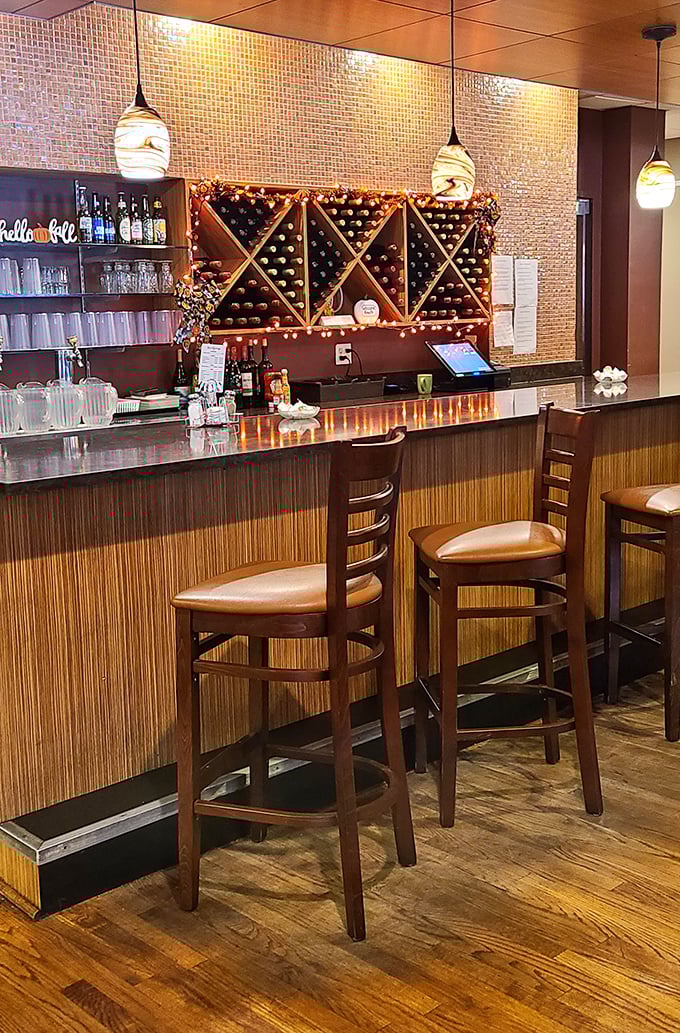 The bar area combines warmth and sophistication, with pendant lighting that makes everyone look like they're in a feel-good movie.