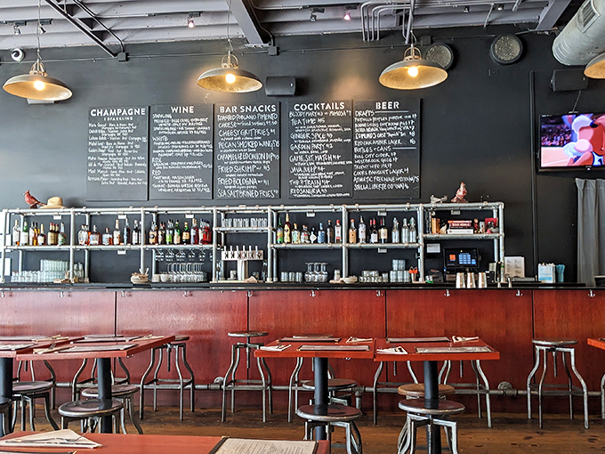 The bar area's chalkboard menus and industrial lighting create the perfect backdrop for decisions that always end with "and another round, please."
