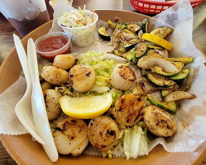 Scallops seared to golden perfection alongside grilled vegetables&mdash;proof that sometimes the simplest preparations yield the most profound pleasures. 