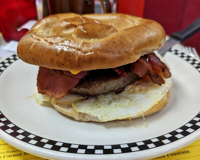 A breakfast sandwich so perfect it deserves its own theme music. The bagel-egg-bacon trifecta that makes mornings worth facing.