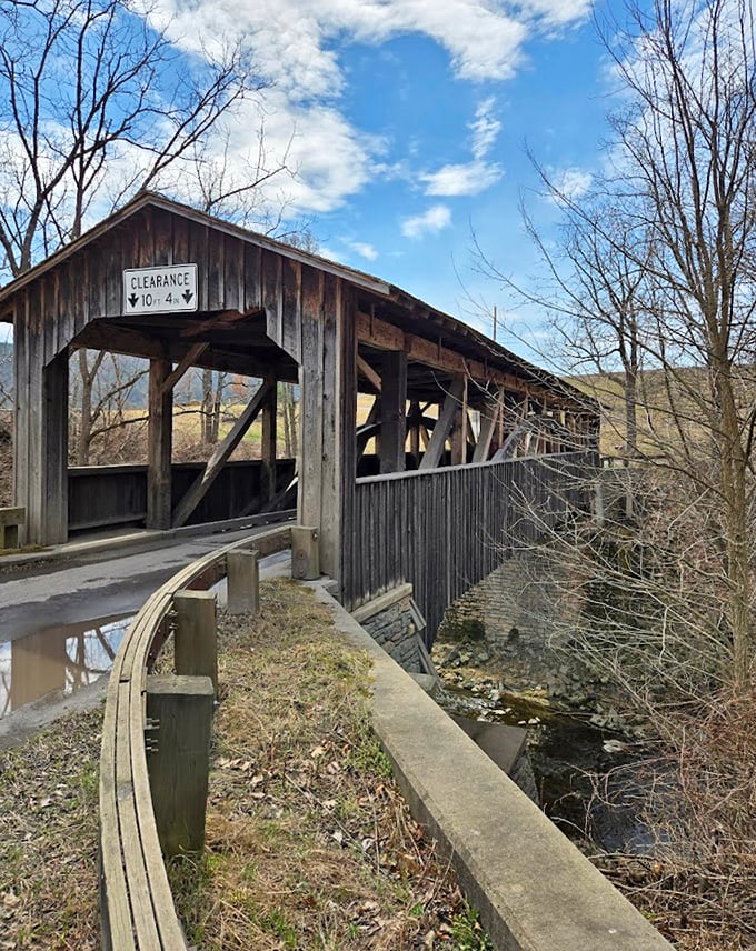 Against a brilliant blue sky, the bridge stands as a wooden exclamation point on the landscape, demanding we slow down and notice.