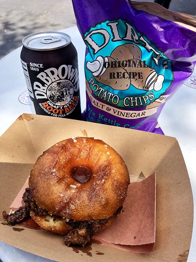 The ultimate portable feast: a brisket donut sandwich alongside Dr. Brown's root beer and chips &ndash; proof that happiness can fit in one hand.