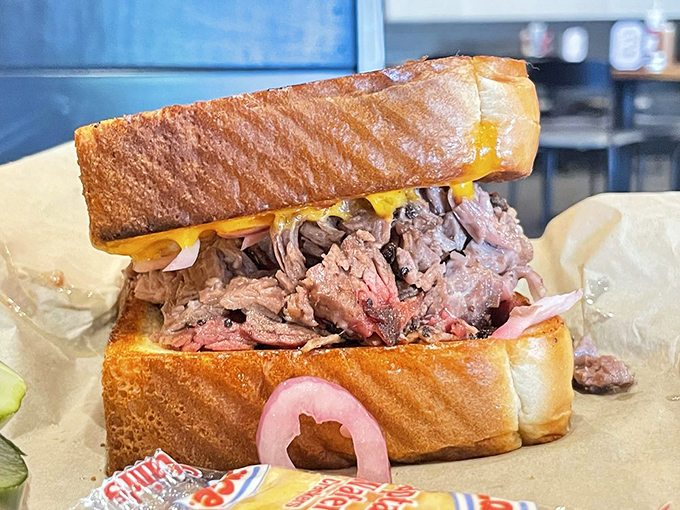 The brisket sandwich: where smoke meets bread in holy matrimony. That pink smoke ring is like barbecue's engagement diamond—proof of commitment.