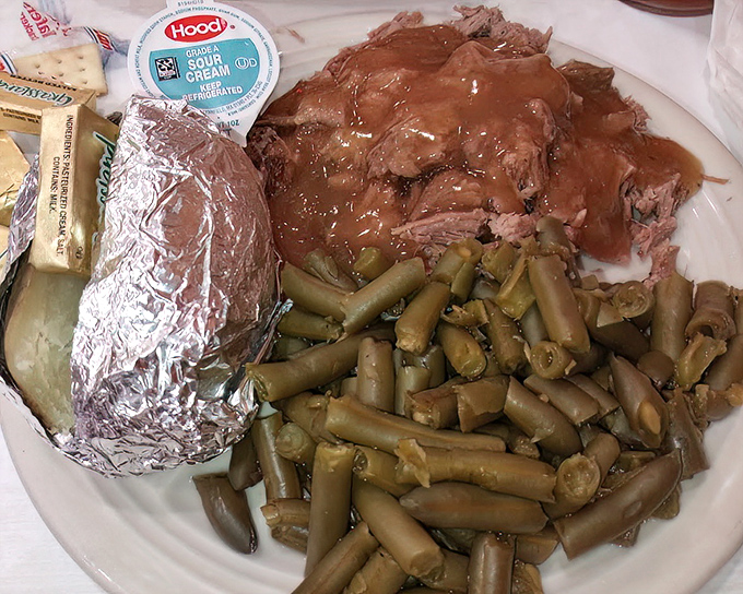 Brisket so tender it surrenders to your fork, green beans that taste like summer, and a baked potato in foil&mdash;the holy trinity of heartland dining.