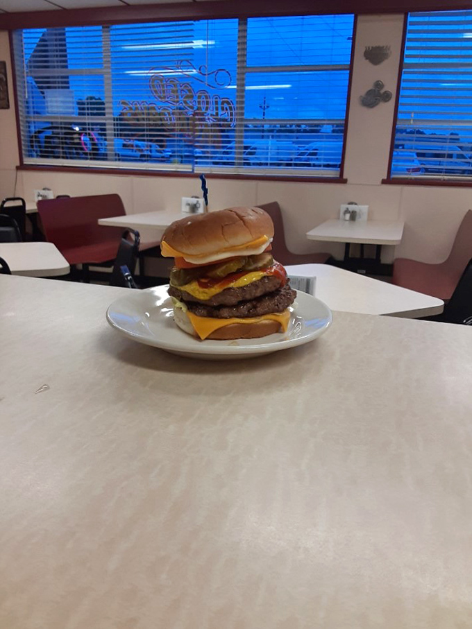 This isn't just a burger – it's a skyscraper of beef, cheese, and toppings that requires both hands and a strategic approach.