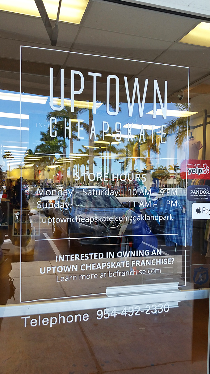 The storefront window reveals extended hours&mdash;because fashion emergencies don't always happen between 9 and 5. Palm trees reflected in the glass add that quintessential Florida touch.