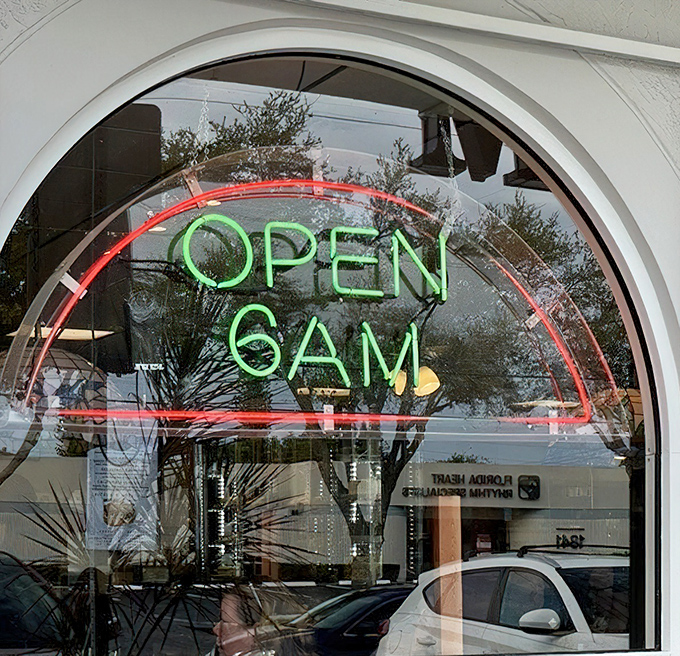 "Open 6 AM" glows in neon &ndash; three little words that promise salvation to early risers and those who understand that breakfast waits for no one.
