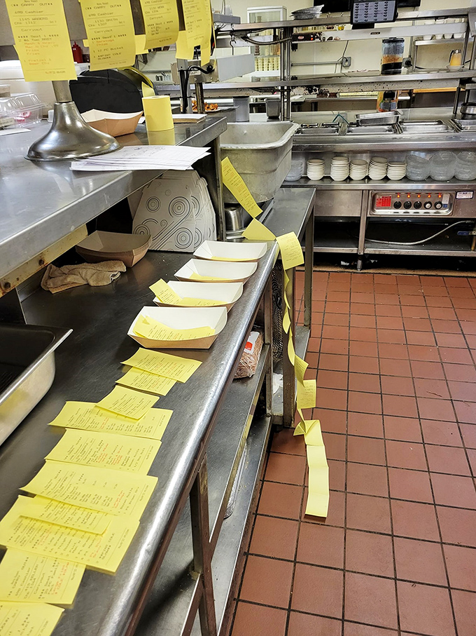 The kitchen's yellow order tickets tell the story of a busy restaurant where organization is as important as seasoning.