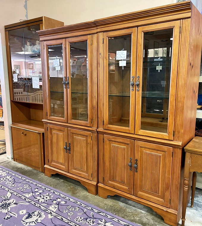 A stately china cabinet that's probably witnessed decades of "we only use these dishes for special occasions" declarations. Solid craftsmanship meets timeless design.