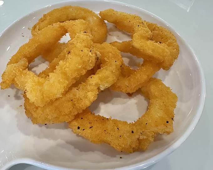 Golden-fried calamari rings&mdash;the gateway seafood for the hesitant. Crispy, tender, and impossible to stop eating once you start.